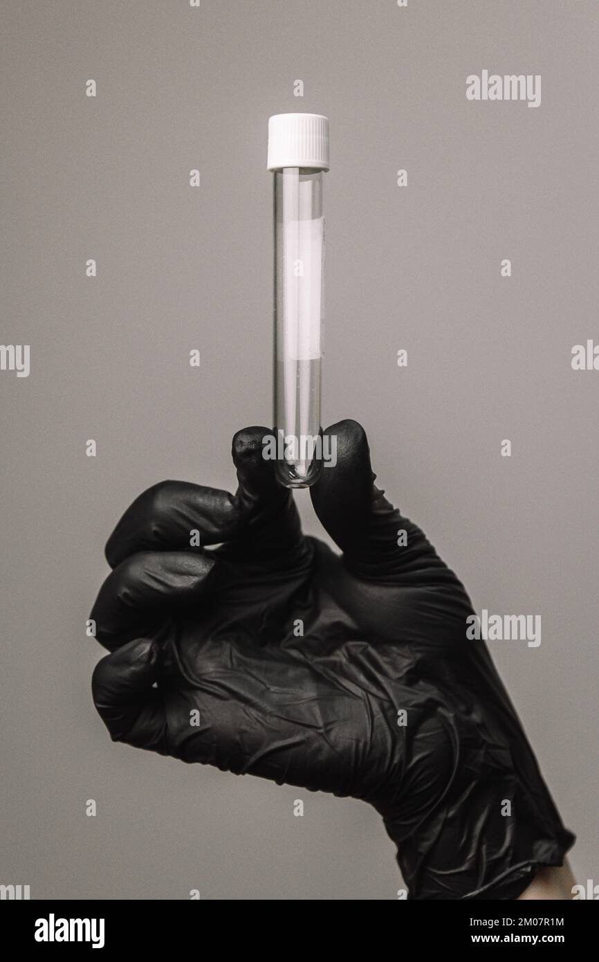 Empty test tube in a glass flask in the hands of a scientist or ...