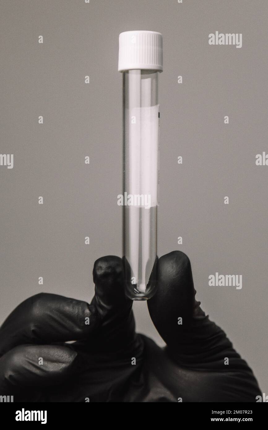 Empty test tube in a glass flask in the hands of a scientist or ...