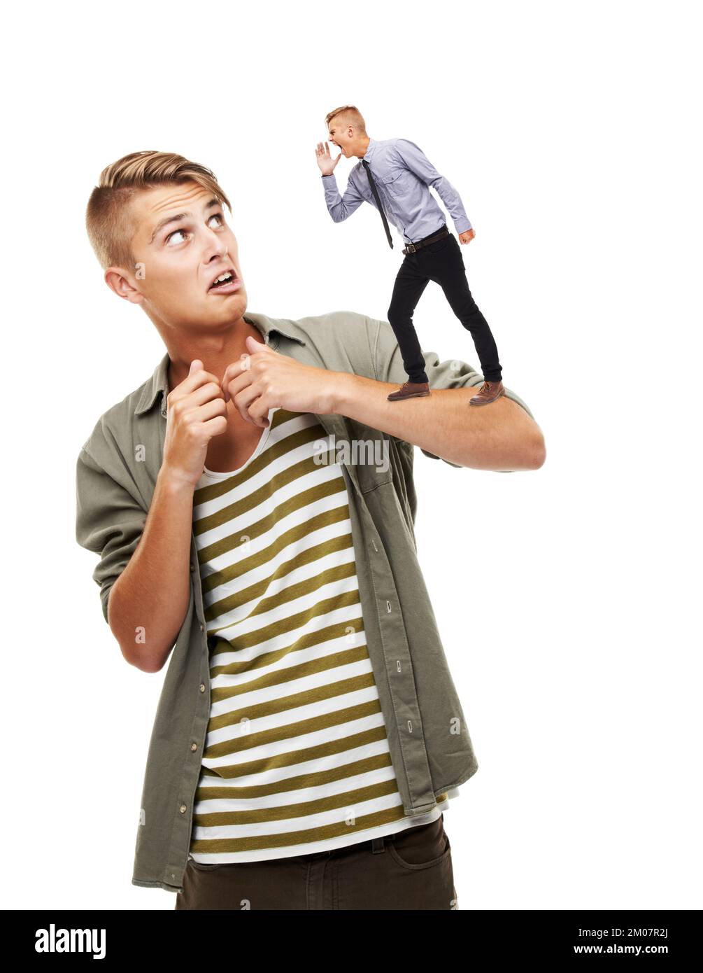 Alter-ego issues. A trendy young man being shouted at by a small alter ...