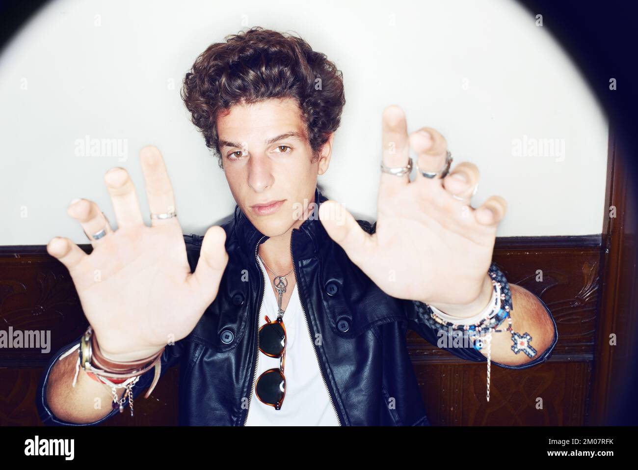 Just chill. Portrait of a stylish young man raising his palms to the ...