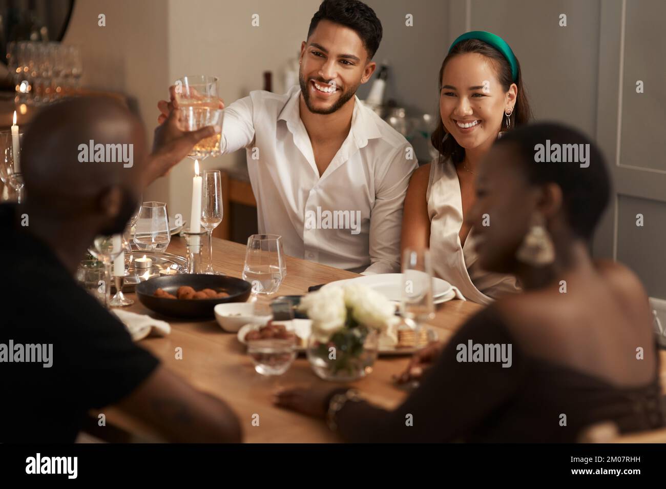 Wine, toast and party with friends at table of dining room for new year ...