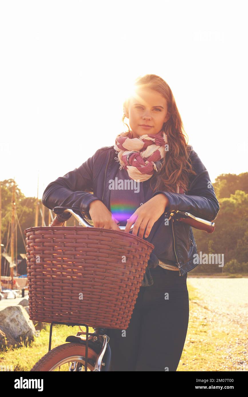 Her daily bike ride. A beautiful woman standing with her bicycle ...