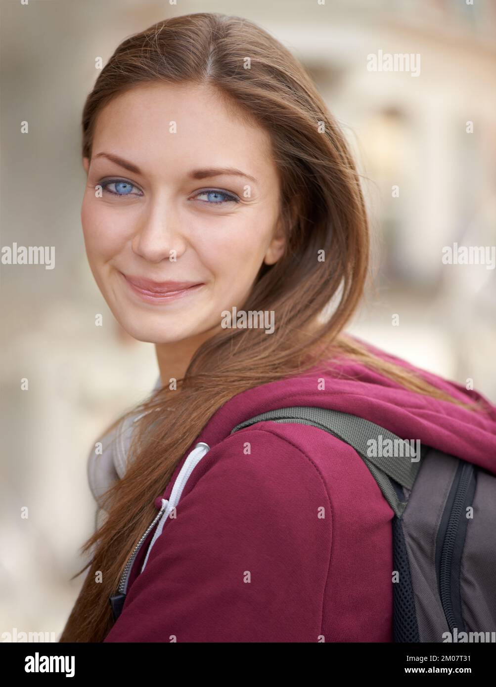 Theres something so lovely about her smile. A lovely young woman turning to give you a sweet ...