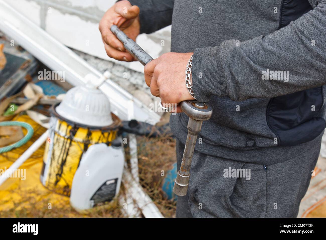 Auto mechanic man with electric screwdriver changing tire outside. Car ...