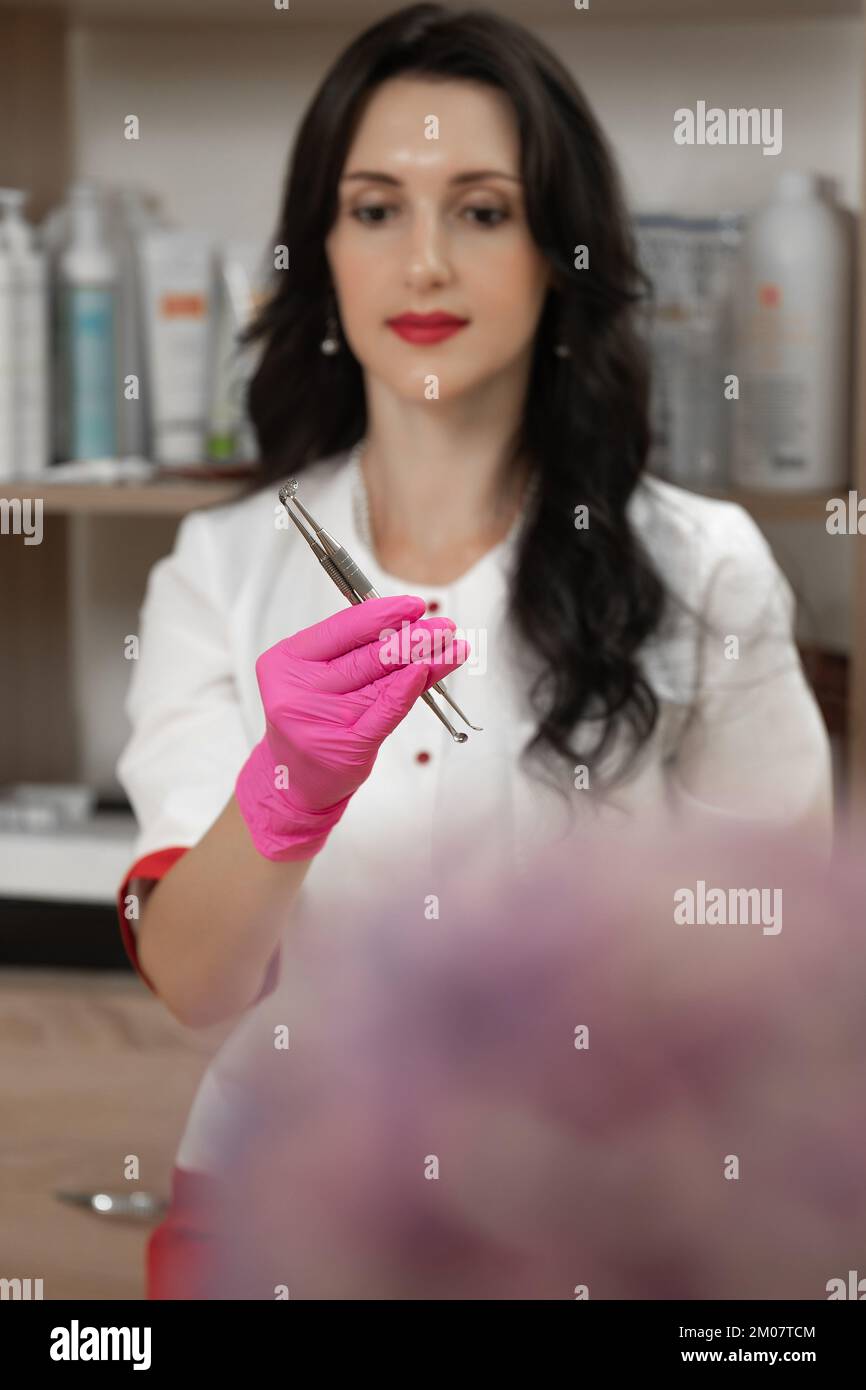 Uno spoons in the hands of a beautician, beautician tools for facial ...