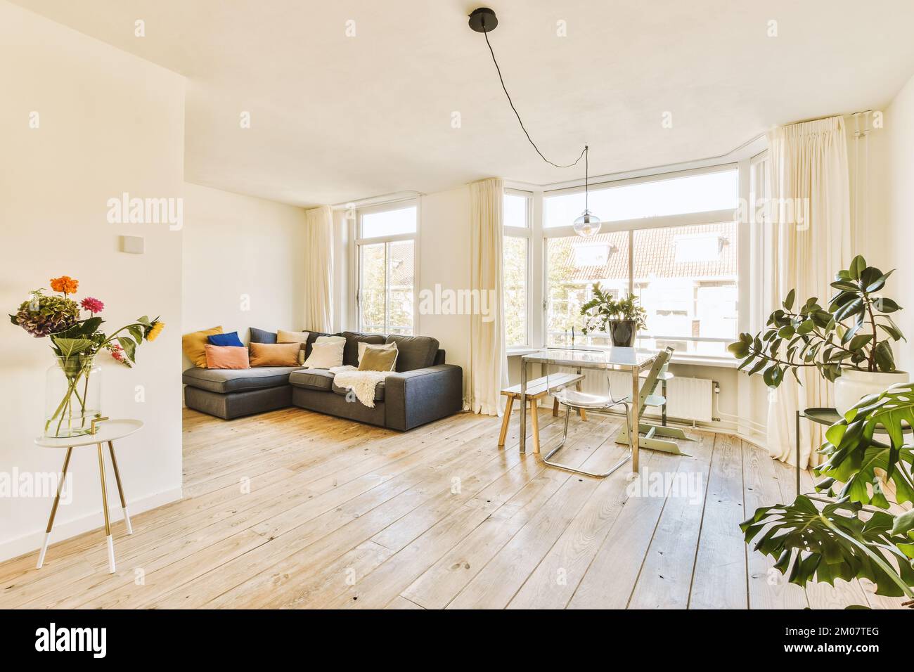 Armchair and sofa located in light room of spacious contemporary ...