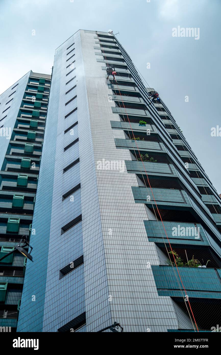 cleaning walls and glass of high-rise buildings in a big city Stock ...