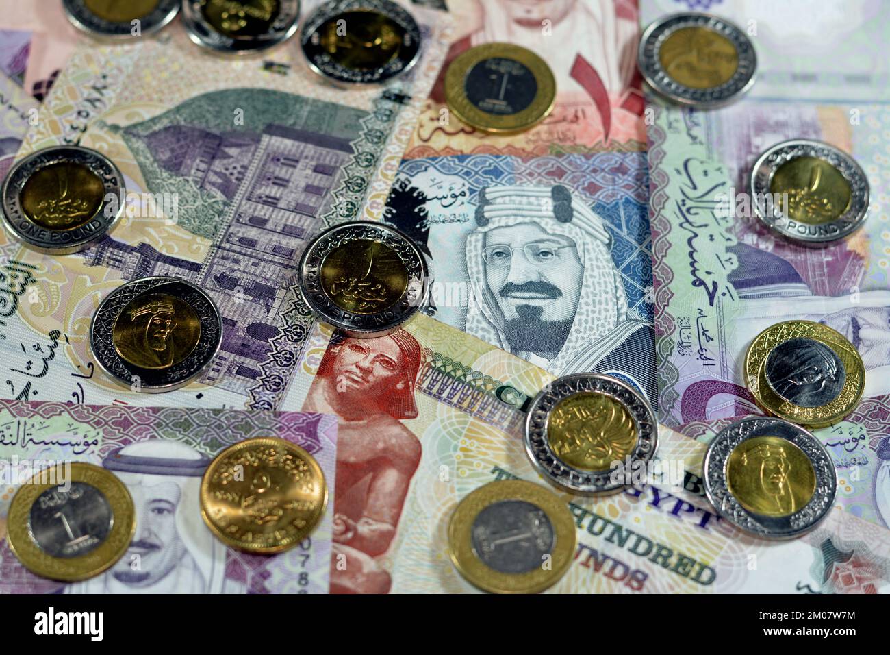 Egyptian pounds cash money banknotes and coins with Saudi Arabia ...