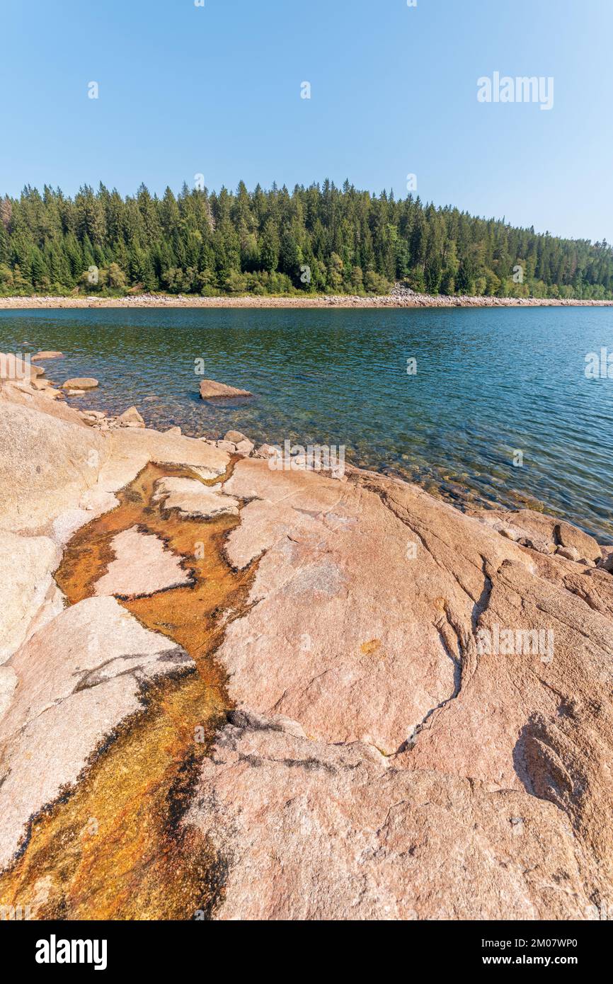 Mountain lake with a drop in the water level in times of drought. Lac ...