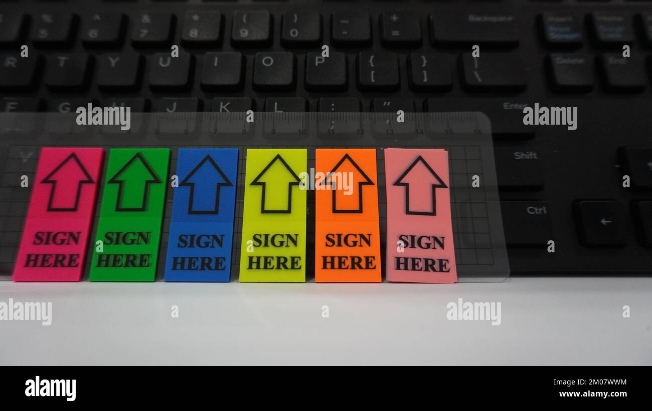 Close up computer keyboard with signature sign marker in office or ...