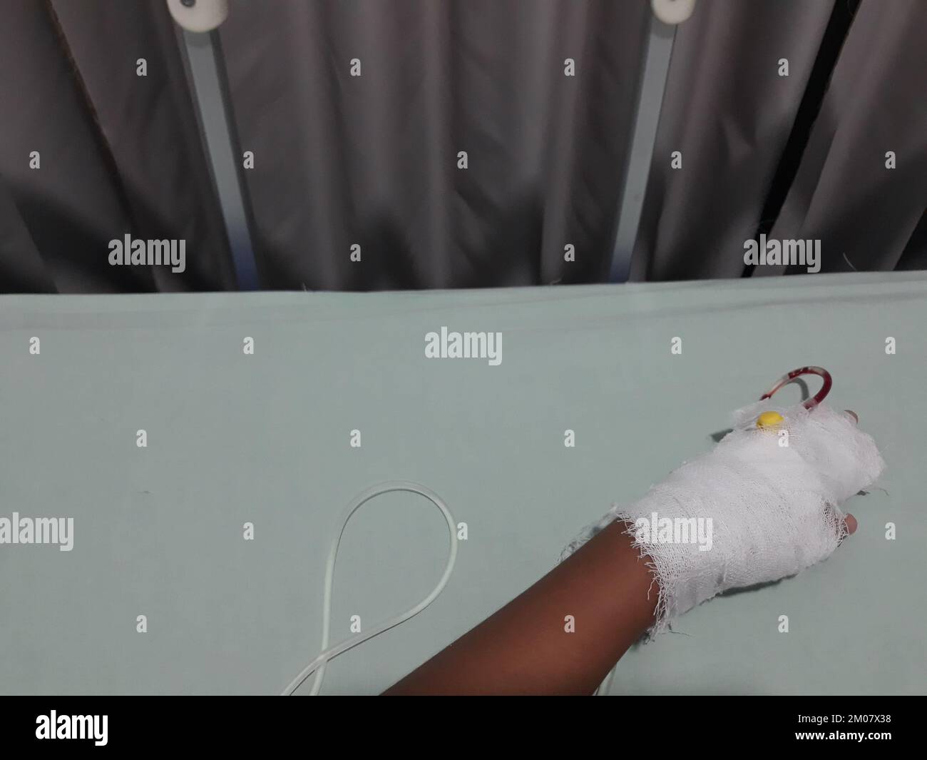 Close up child's young teenage hand being infusion at the hospital room ...