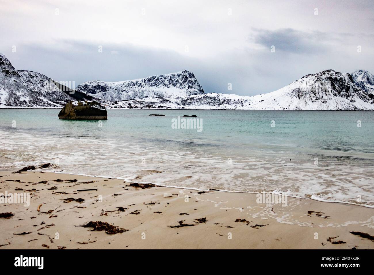 scenic landscape with beach, ocean and mountains near Nusfjord town at ...