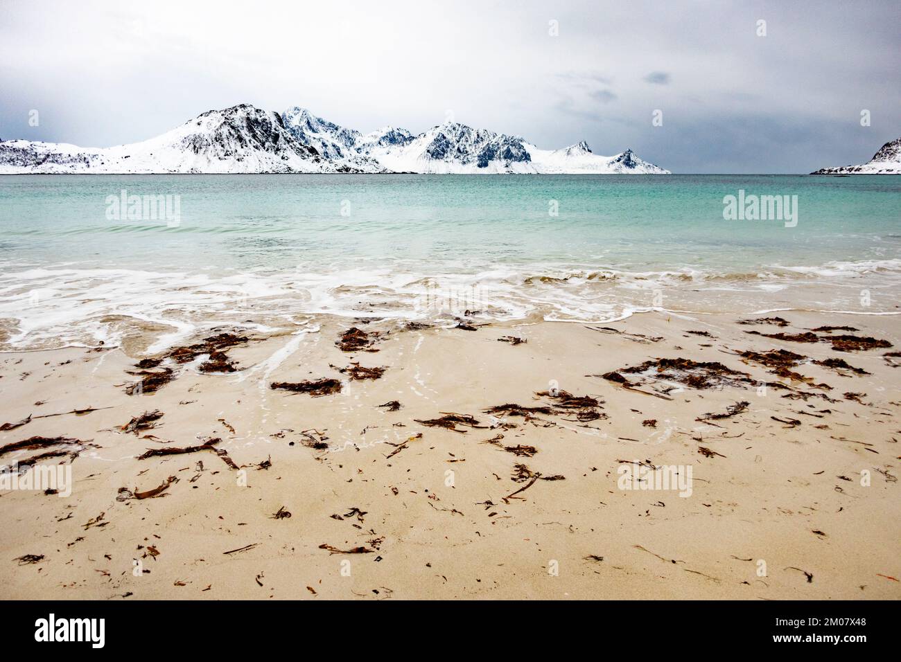 scenic landscape with beach, ocean and mountains near Nusfjord town at ...