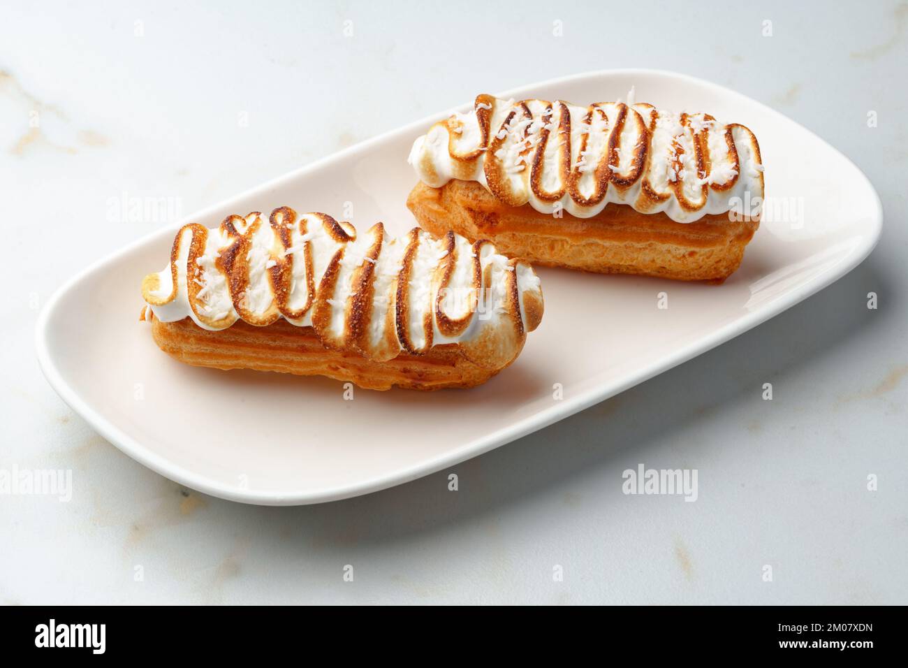 Eclairs with cream decorating of Swiss meringue frosting Stock Photo ...