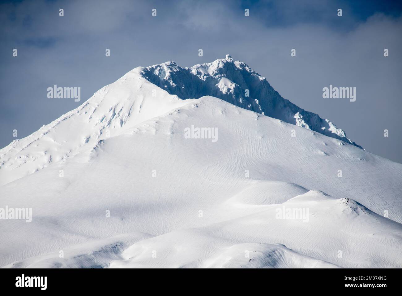 A snow-covered mountain peak against a cloudy sky in Chile Stock Photo ...