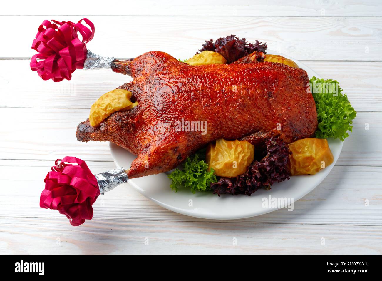 Oven baked duck with herbs and fruits on white plate Stock Photo - Alamy