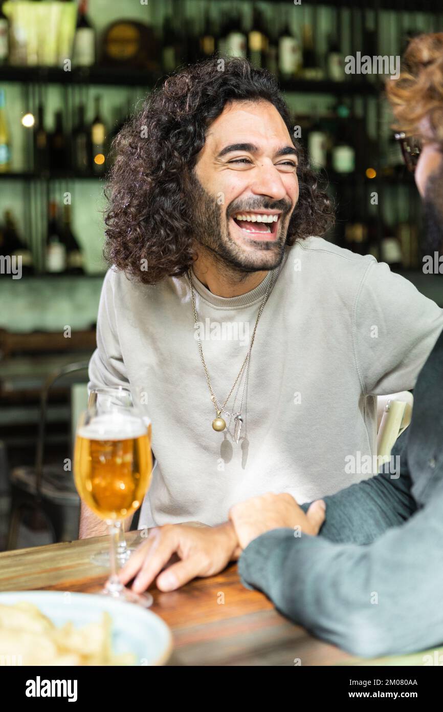 Young men having fun drinking beer at brewery bar Stock Photo - Alamy
