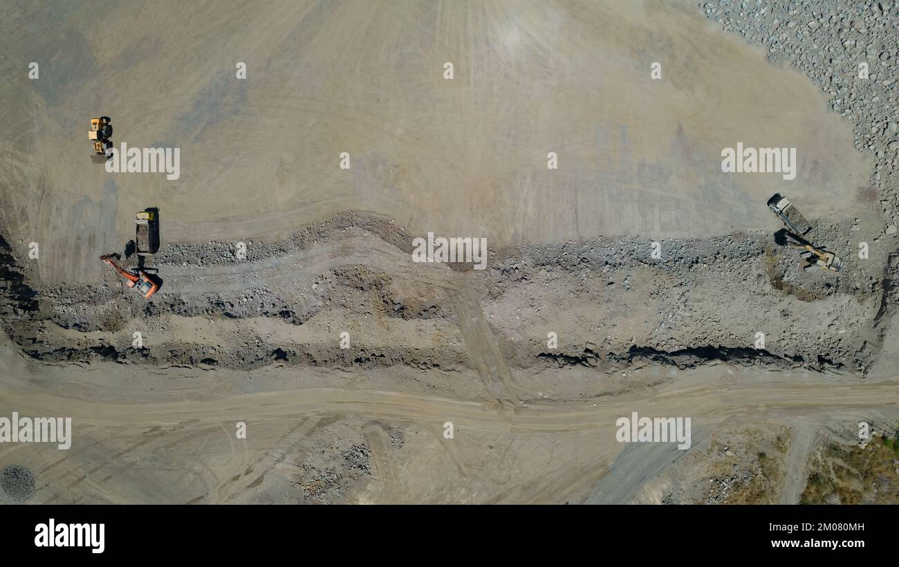 A top view shot of several industrial machines working in a cement ...