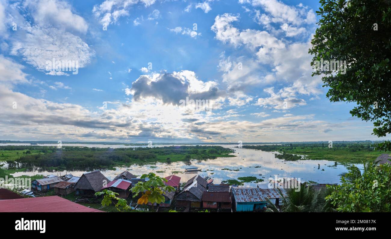Amazon river flood in Peru, Iquitos, small huts in the foreground Stock ...