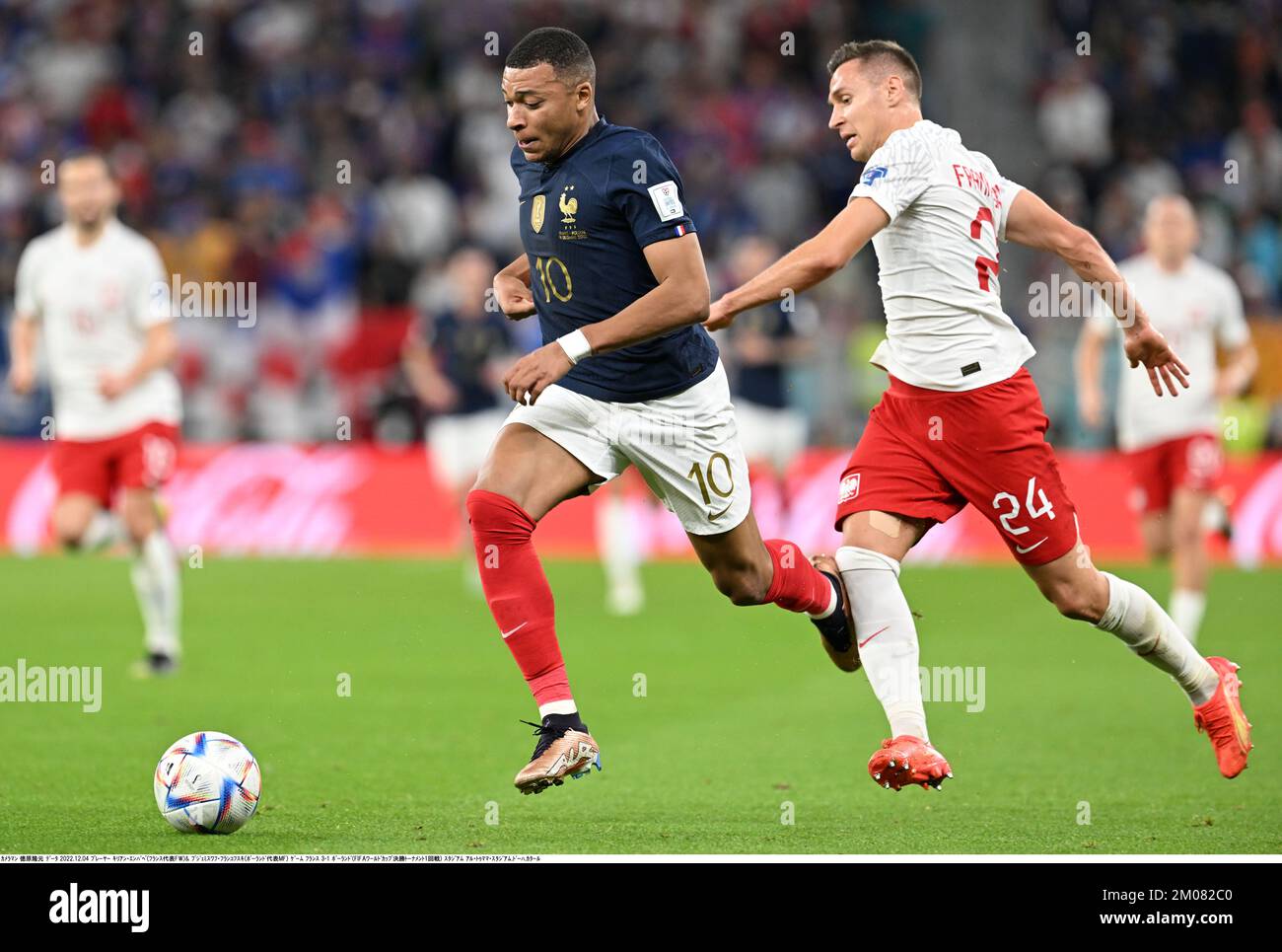 Kylian Mbappe (10) of France and Przemyslaw Frankowski (24) of Poland ...