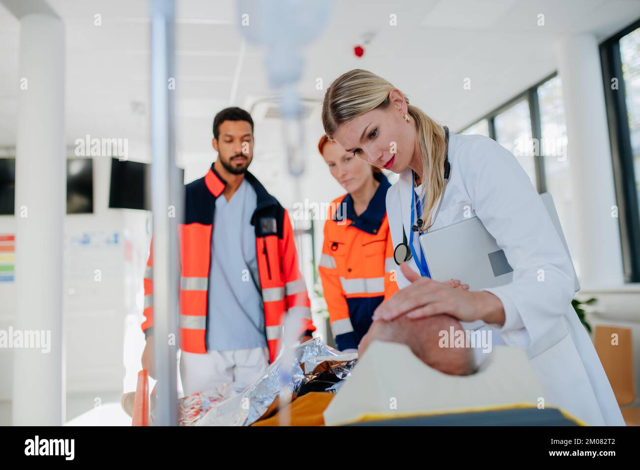Young woman doctor taking care of patient from rescue ambulance Stock ...