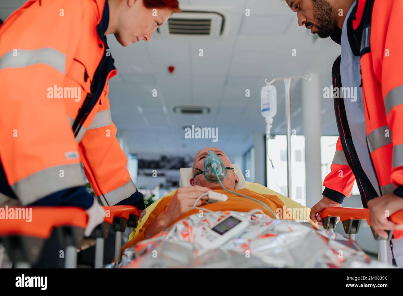 Rescuers taking care of patient from ambulance Stock Photo - Alamy