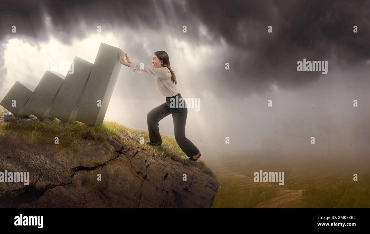 Asian businesswomen hold back the falling graph with dramatic sky ...