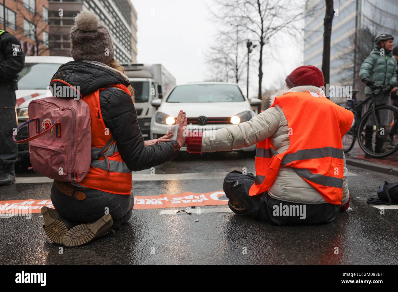Berlin, Germany. 05th Dec, 2022. Climate activists sit with their hands ...
