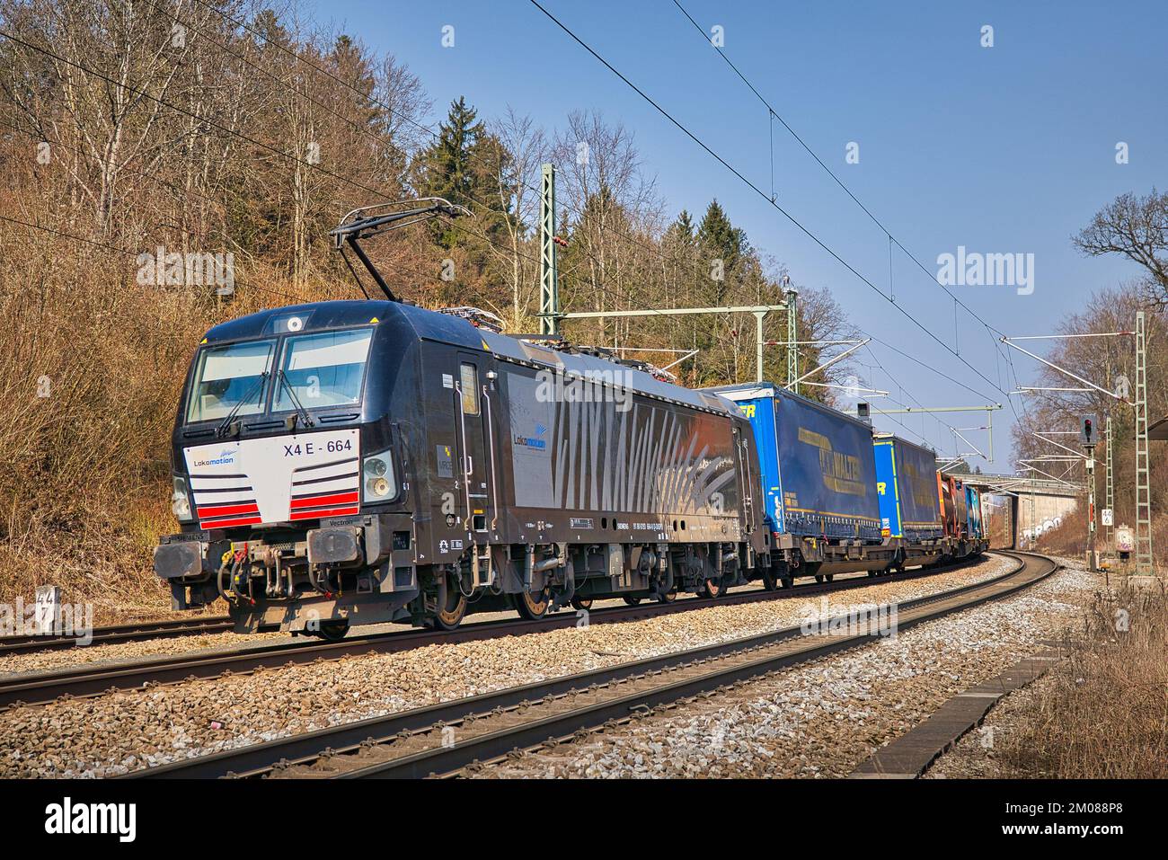 A Lokomotion freight-carrying train traveling through Assling Germany ...
