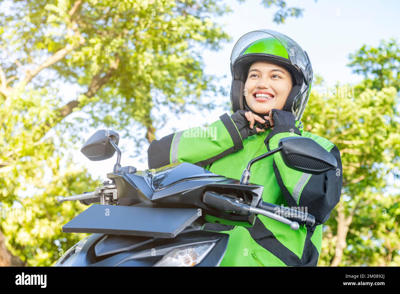Asian woman works as a motorcycle taxi driver on the street Stock Photo ...