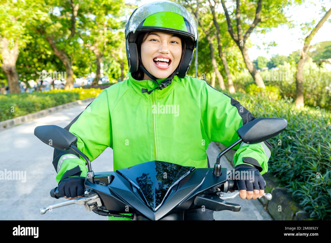 Asian woman works as a motorcycle taxi driver on the street Stock Photo ...