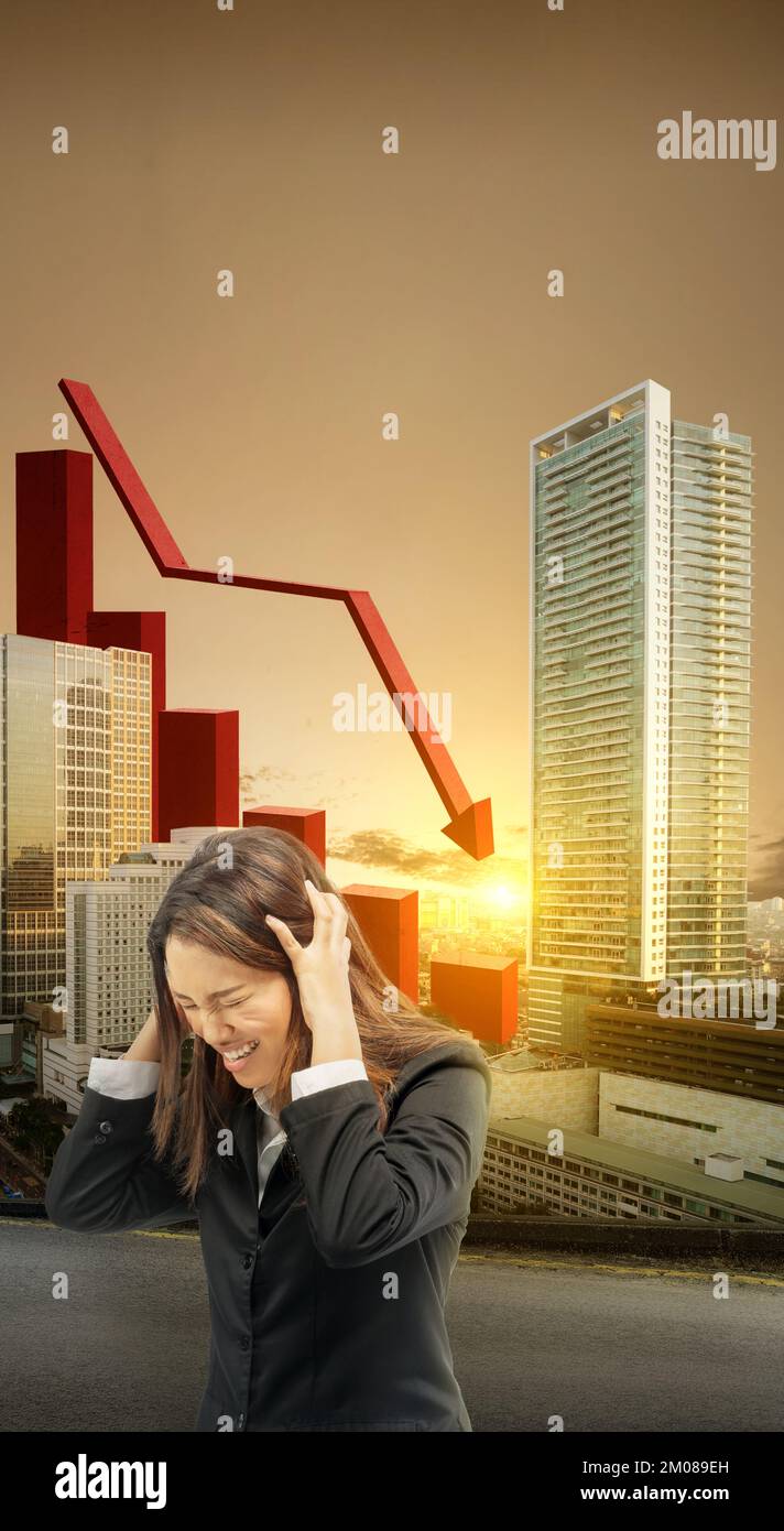 Asian businesswomen are frustrated with a decreased graph with a ...