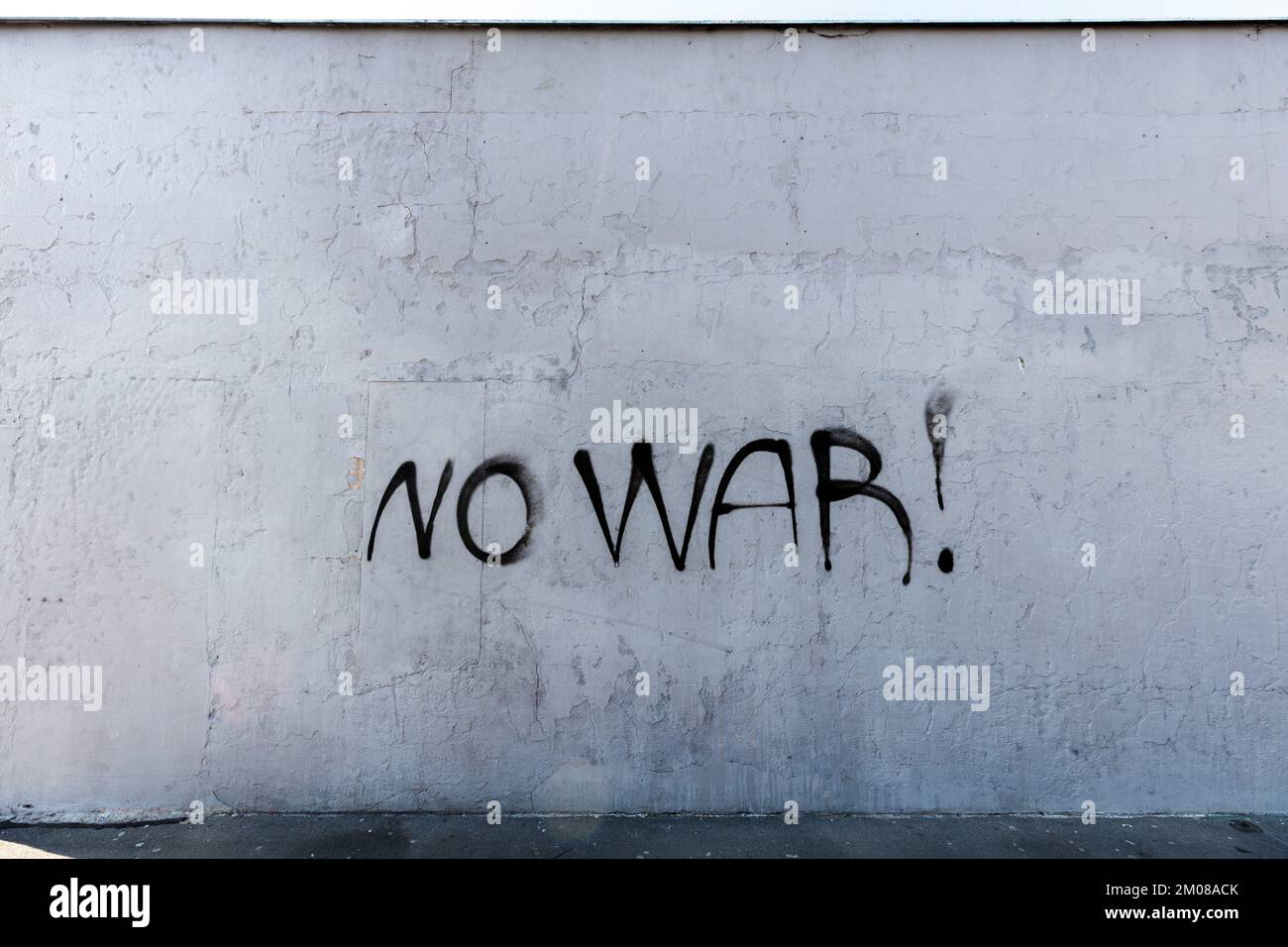 Berlin wall with graffiti painting showing political statement in ...