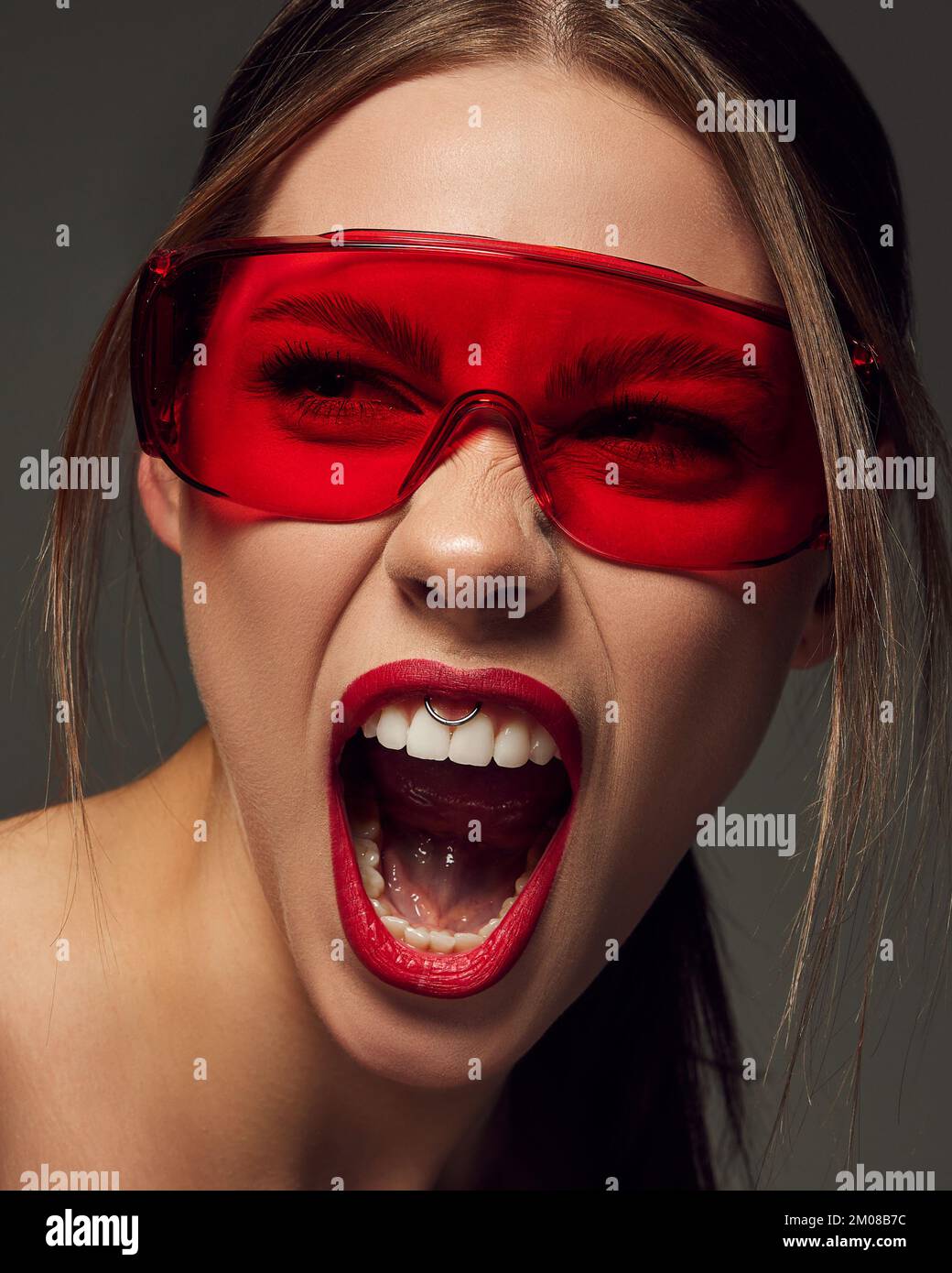 Close Up Portrait Of Emotive Beautiful Young Woman In Red Glasses