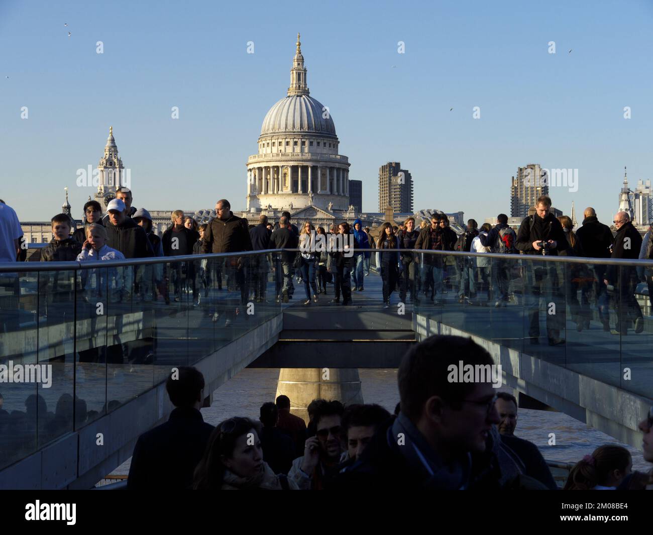 People walking along the Millennium Bridge in London between St Paul's ...