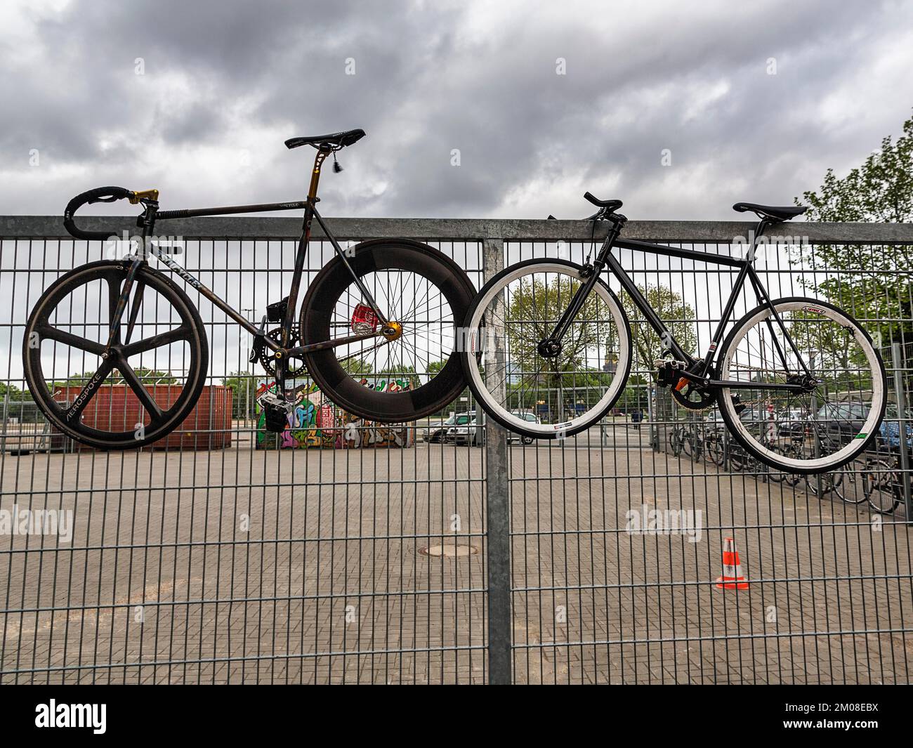 Two bicycles hanging locked on a metal fence, symbolic image security ...