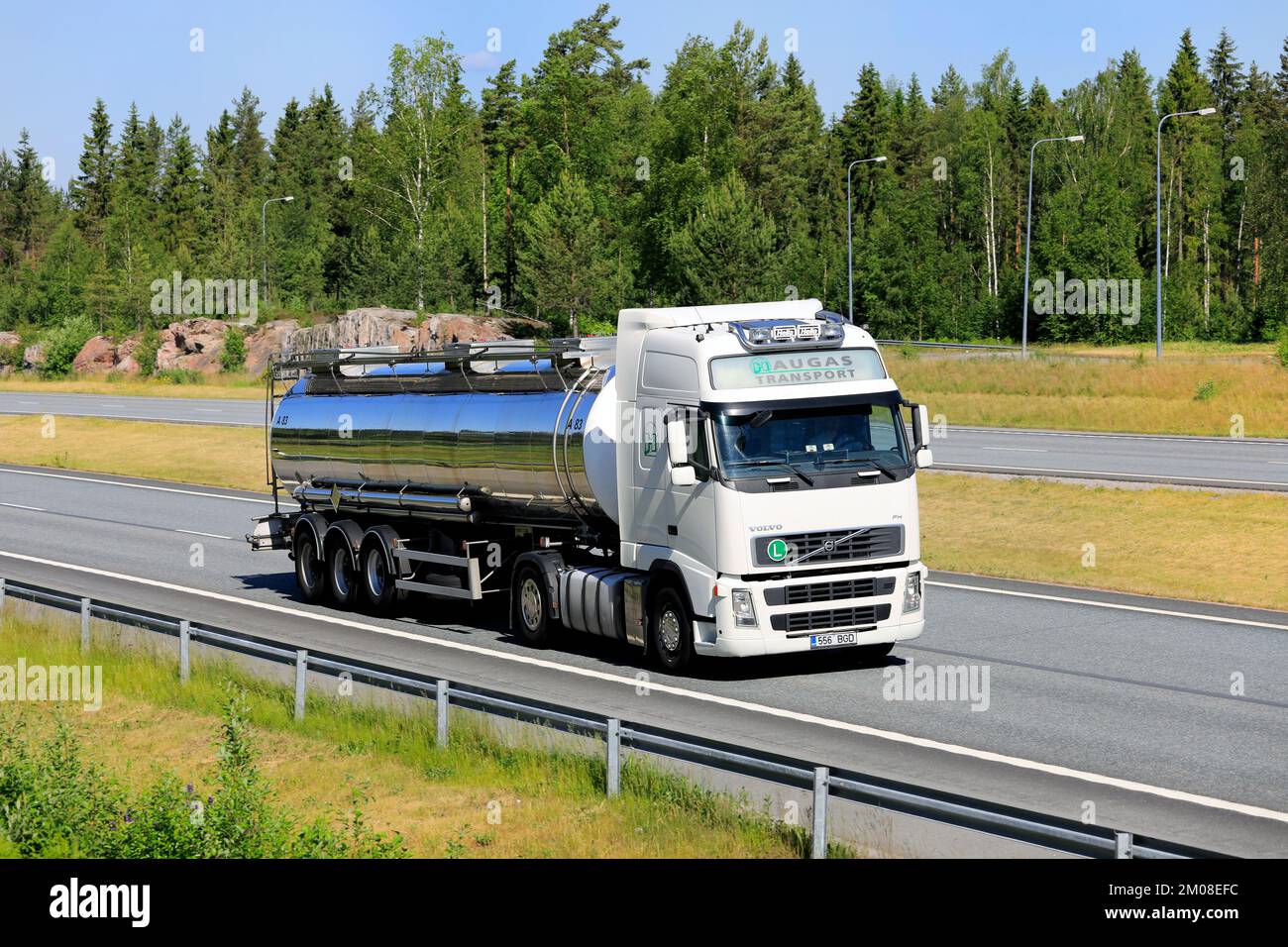 White Volvo FH truck Haugas Transport pulls semi tank trailer on ...
