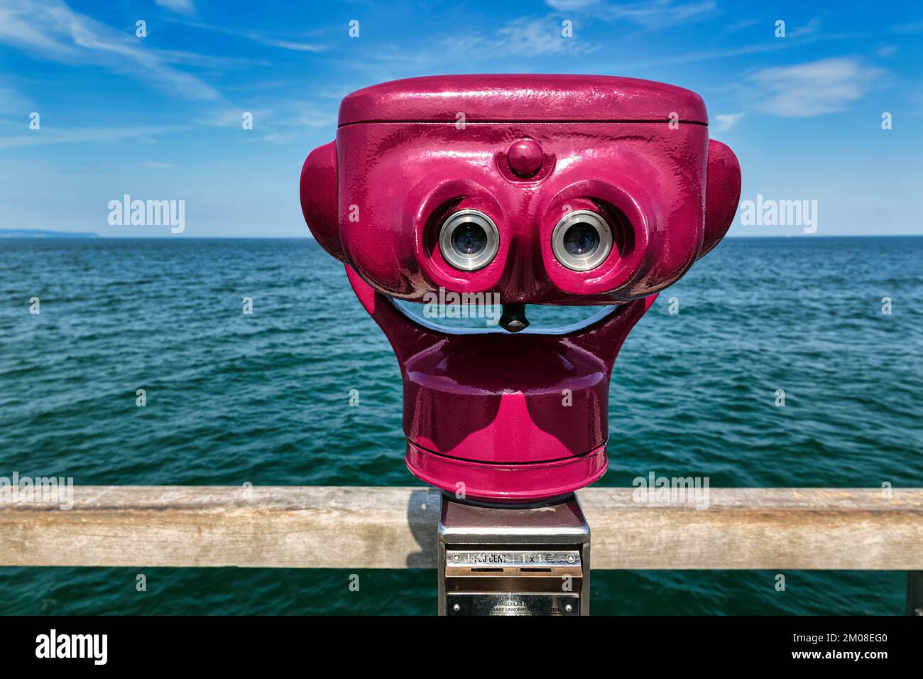 Red telescope on pier, coin telescope points to water, sunny weather ...