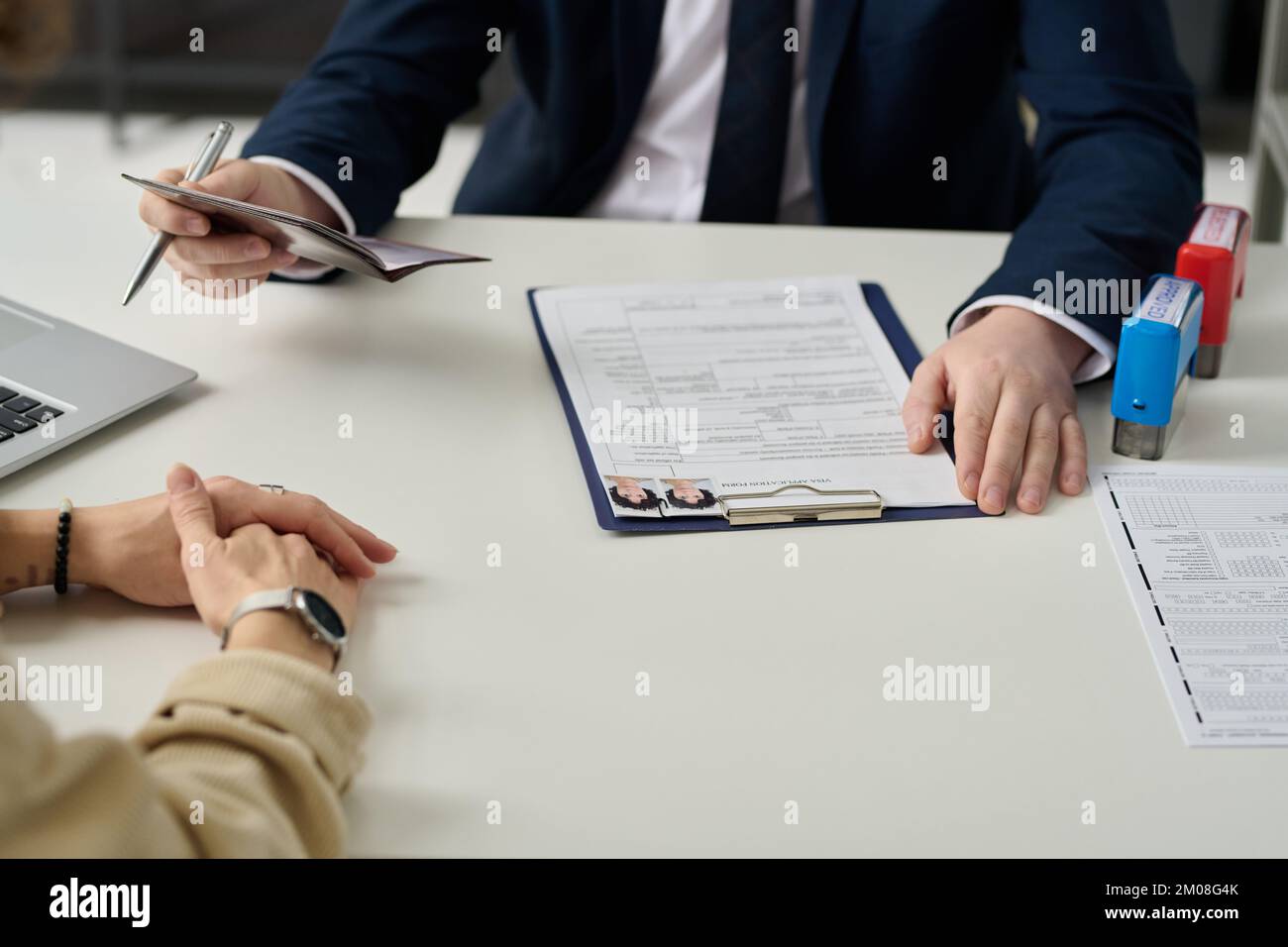 Close up of visa application form with photos and documents on table in ...