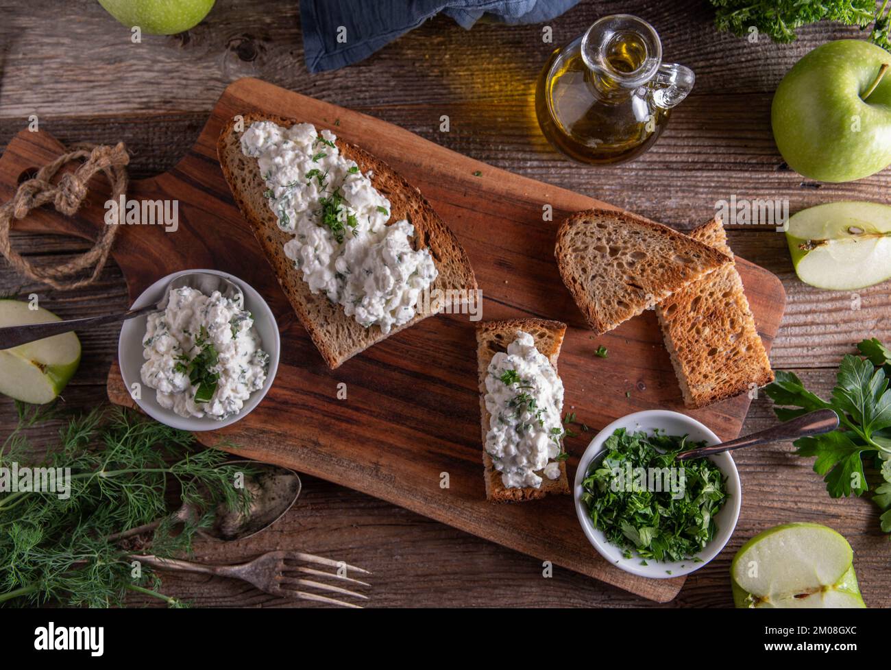 Roasted rye bread with cottage cheese salad on wooden table. Flat lay ...