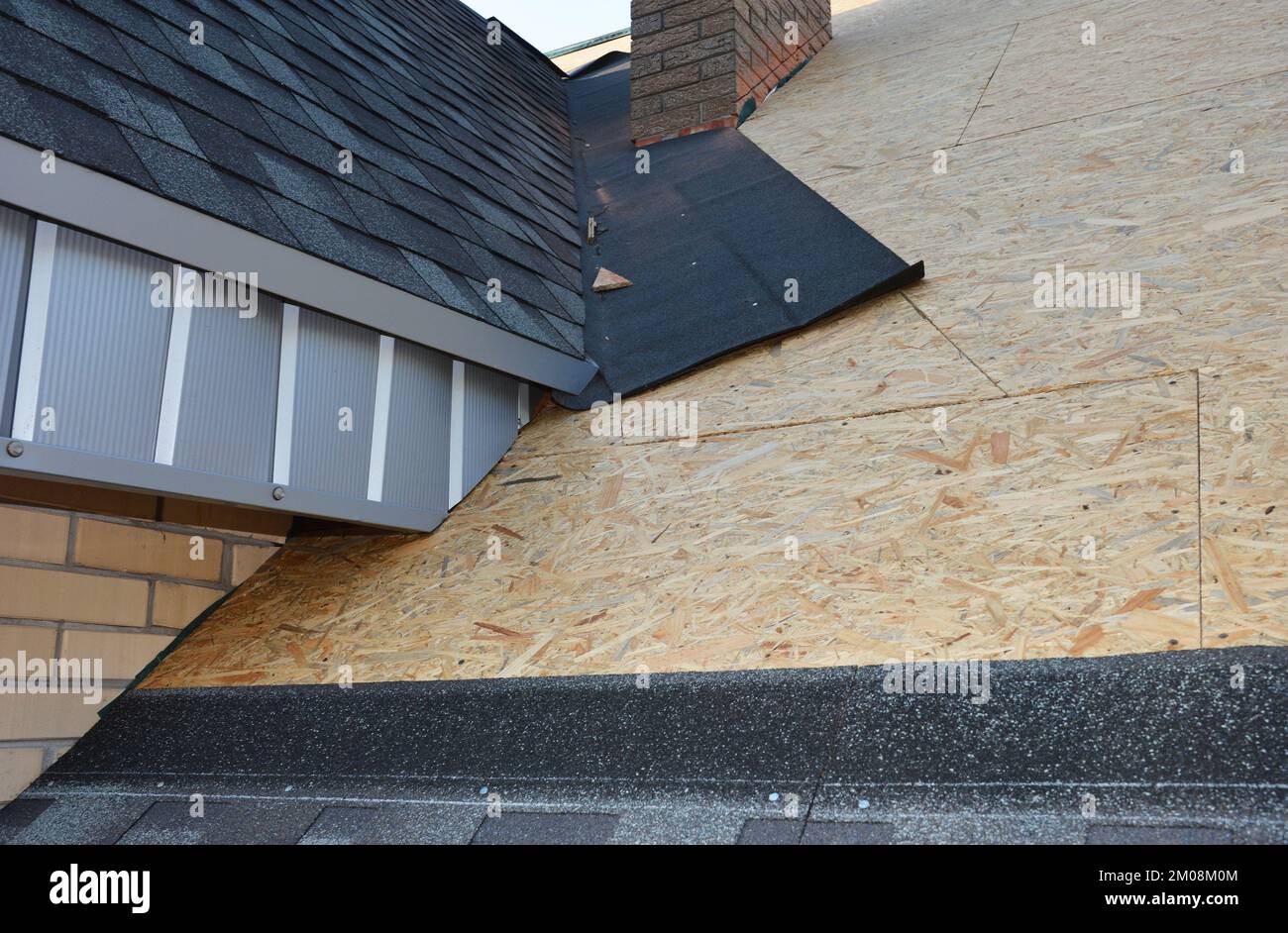 Roofing construction with asphalt shingles corner waterproofing. Close ...
