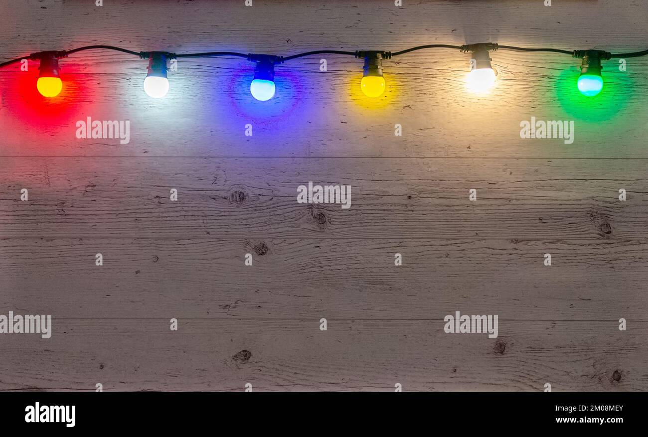 Color lamps garland on the pale wooden background on top Stock Photo ...