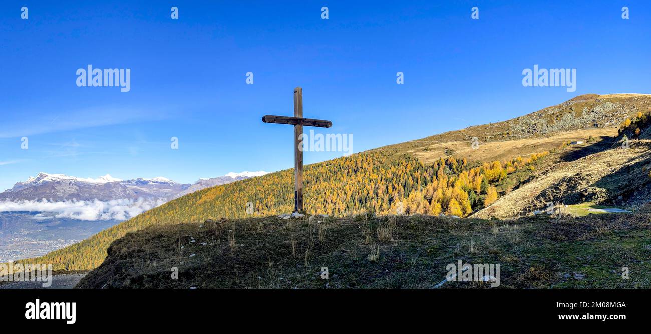 Mountain cross, view of the Lower Valais with autumn forest, Alpage de ...