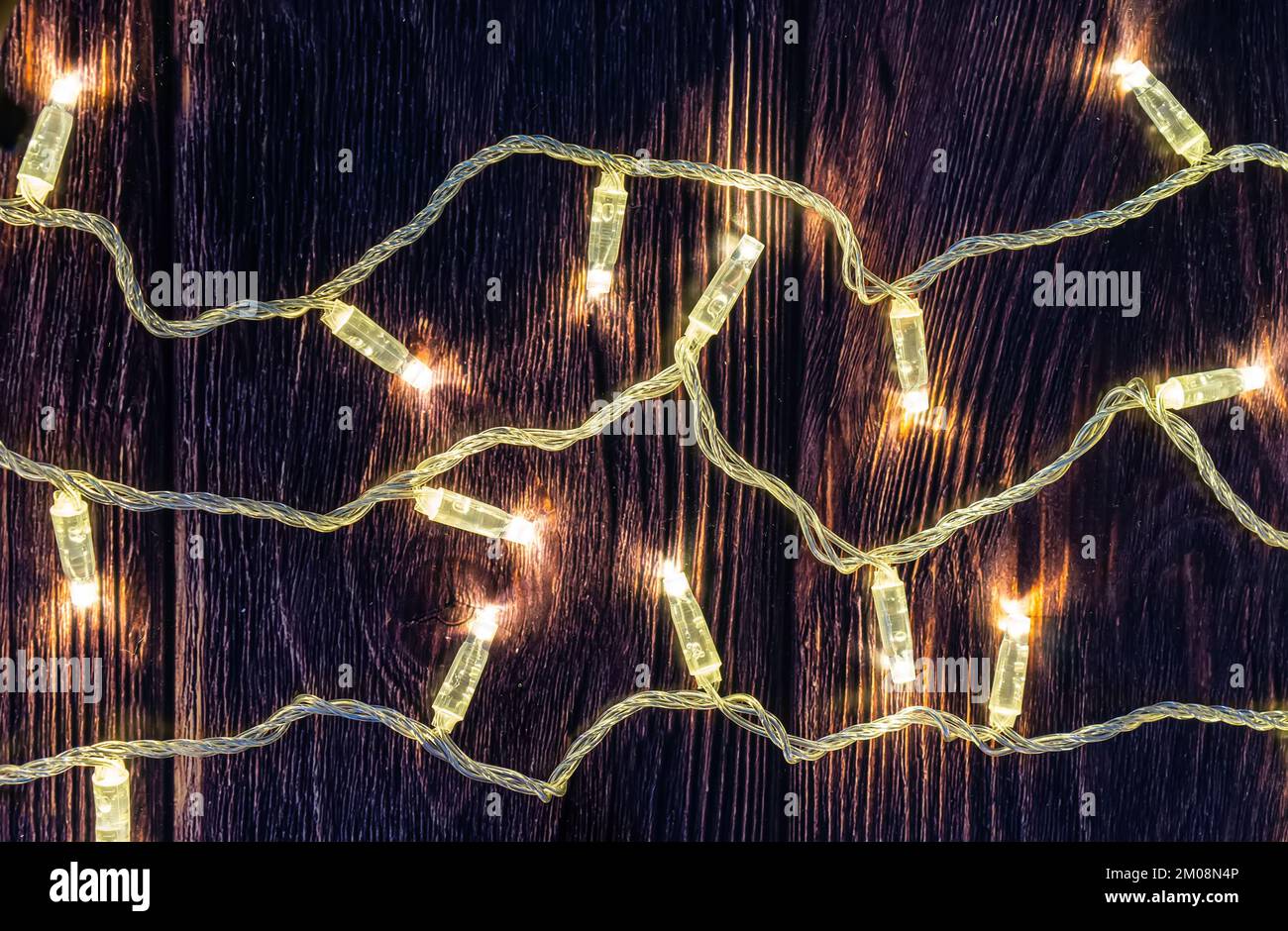 Christmas garland with warm white led and transparent wire on dark wood ...