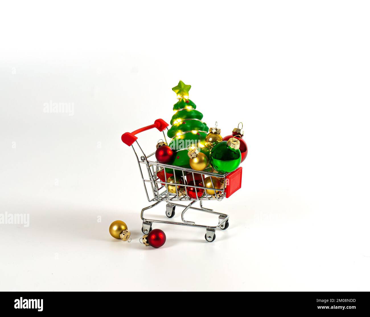 Shopping trolley with christmas balls and tree with garlands. Plain ...