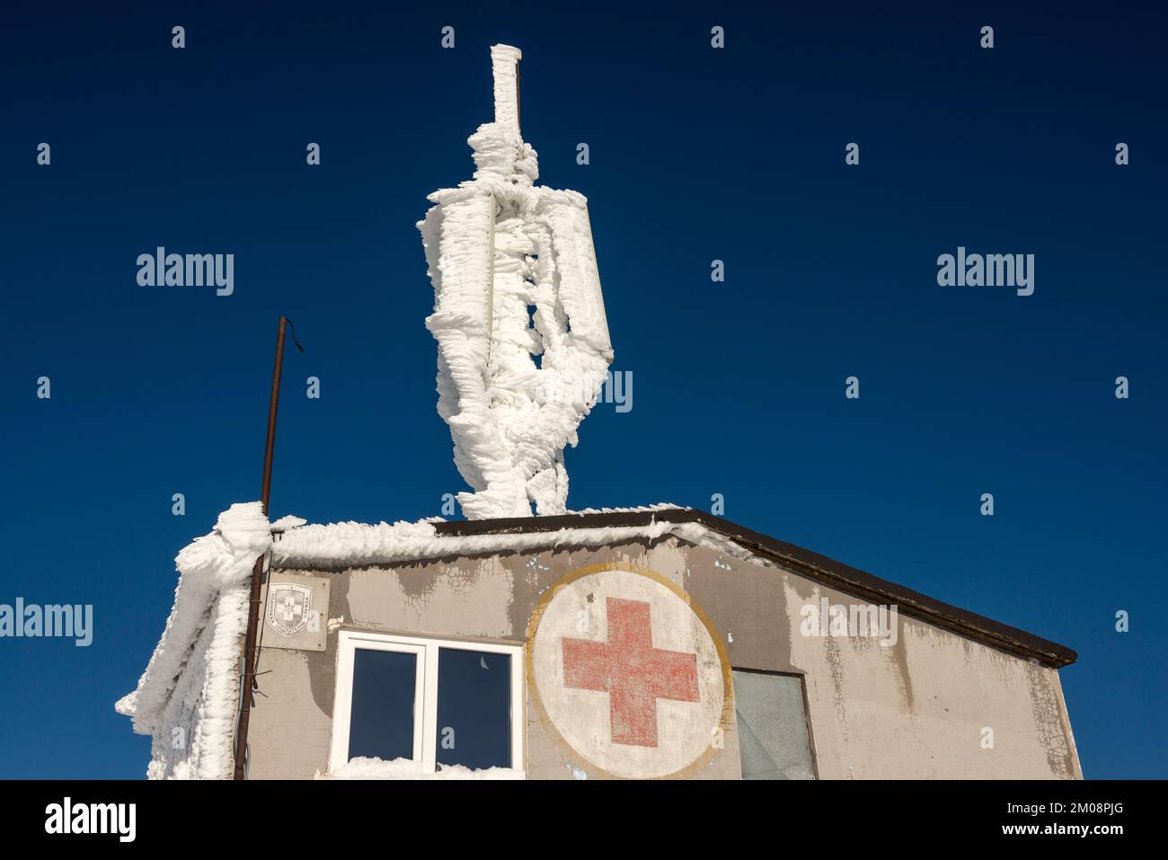 Emergency rescue hut with frozen rime ice antennas at the Black Peak in ...
