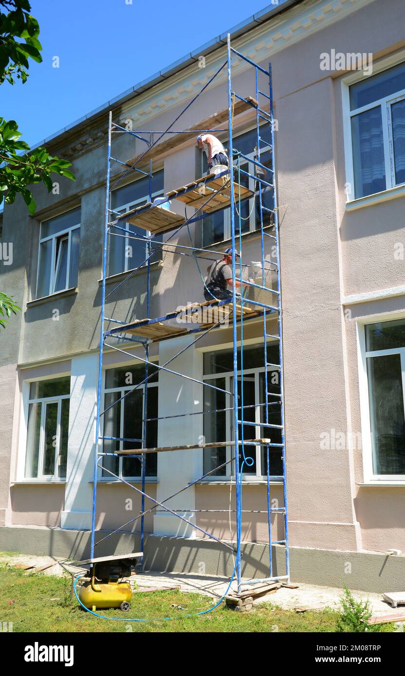 Building contractors are painting house facade wall. Painting exterior ...