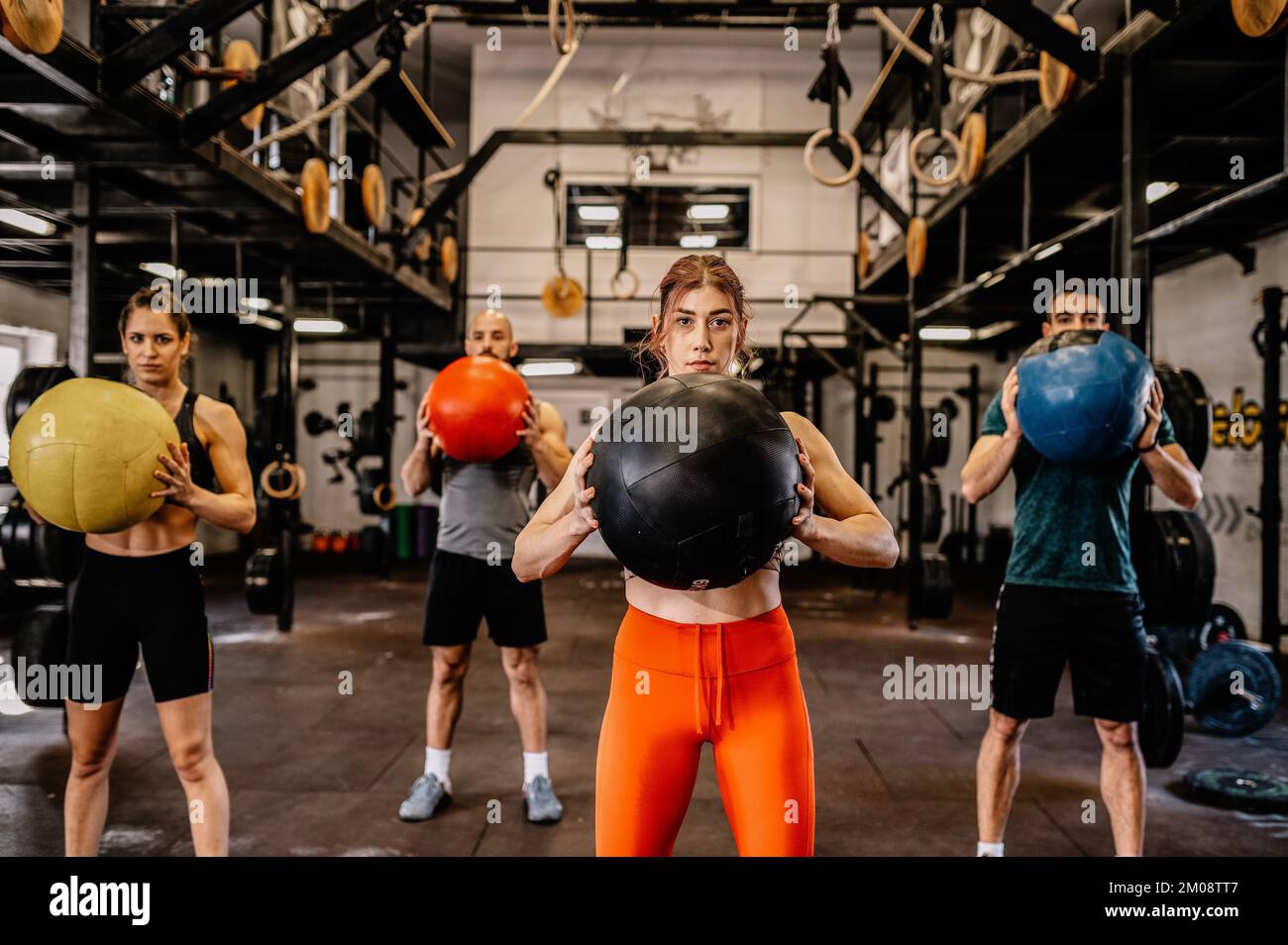 Sporty people in sportswear using exercise ball while having workout at ...