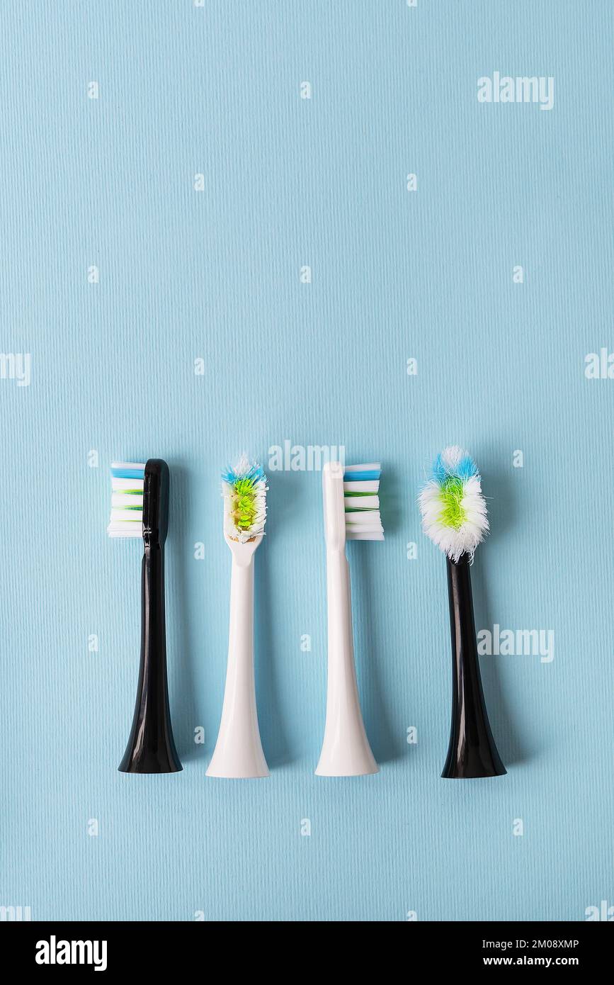 Modern electric toothbrush on a blue background, it's time to change ...
