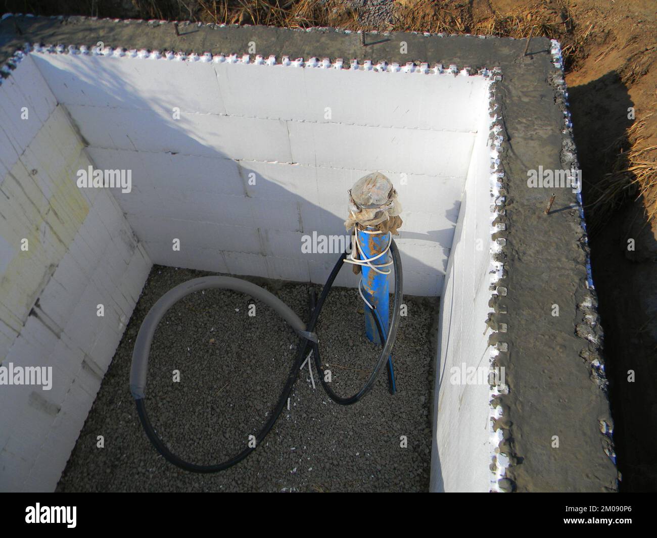 A borehole for water pump station with styrofoam and concrete walls. Borehole construction and ...